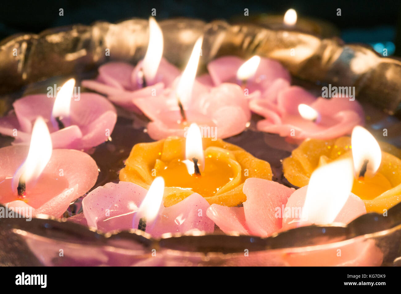 Beautiful floating candles lit and floating on a glass bowl of water ...