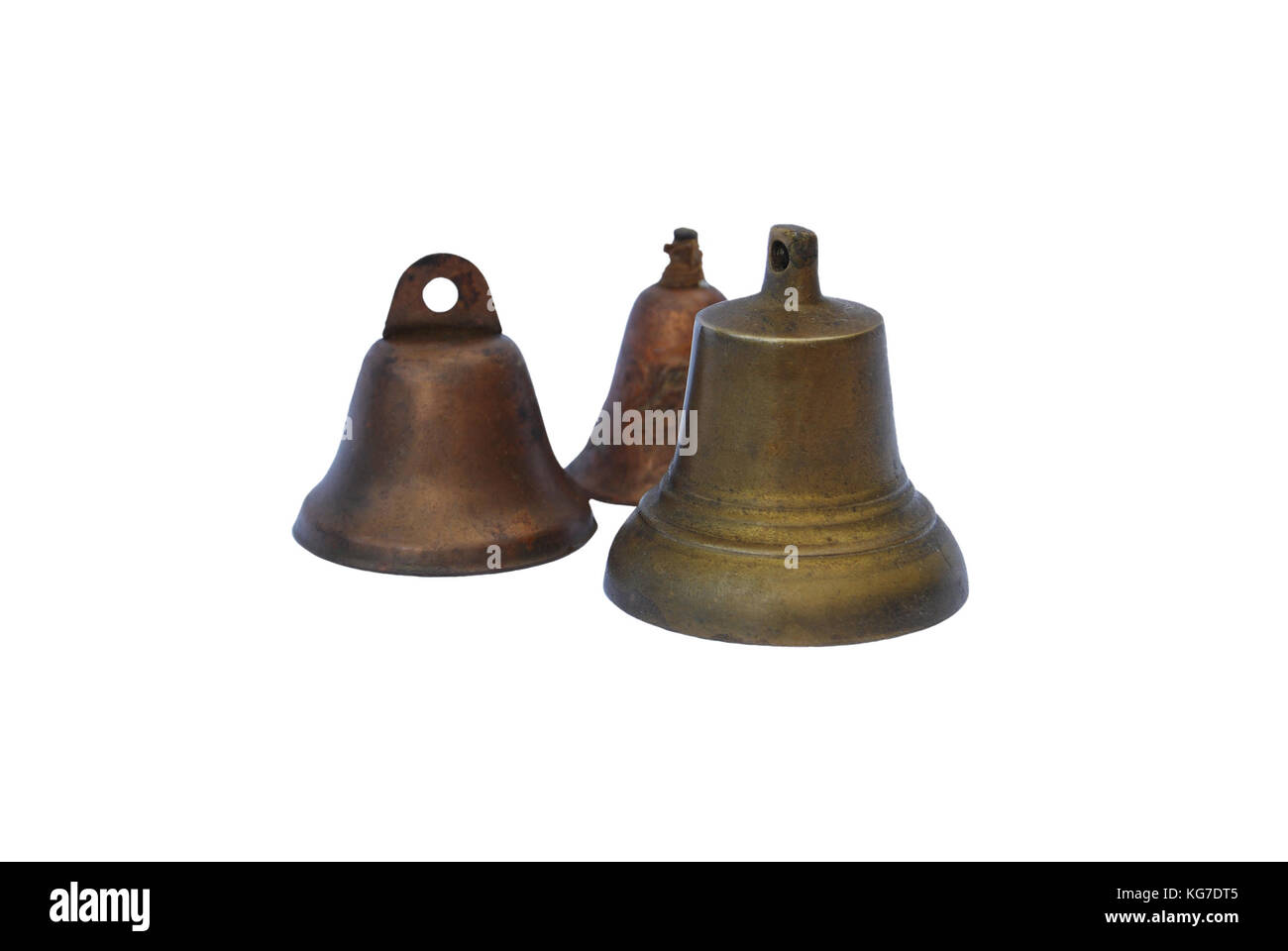 Three vintage brass bells isolated on white background Stock Photo - Alamy