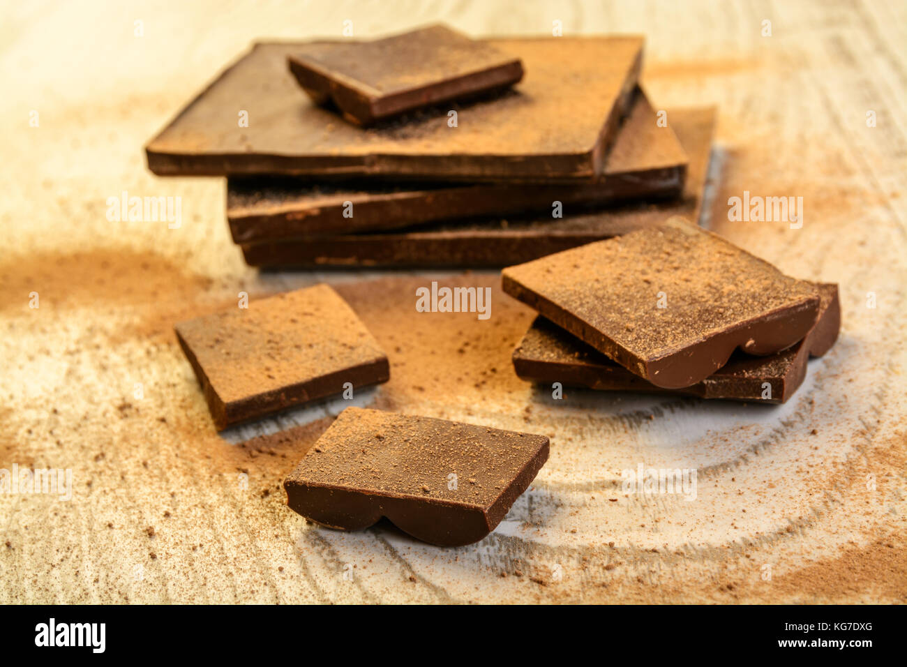 chocolate tablets with pieces on different sizes on bright wood ...