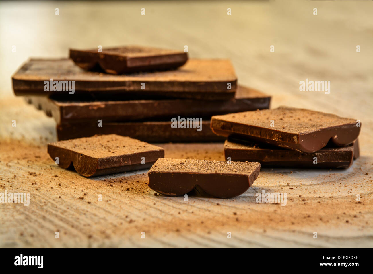 chocolate tablets with pieces on different sizes on bright wood ...