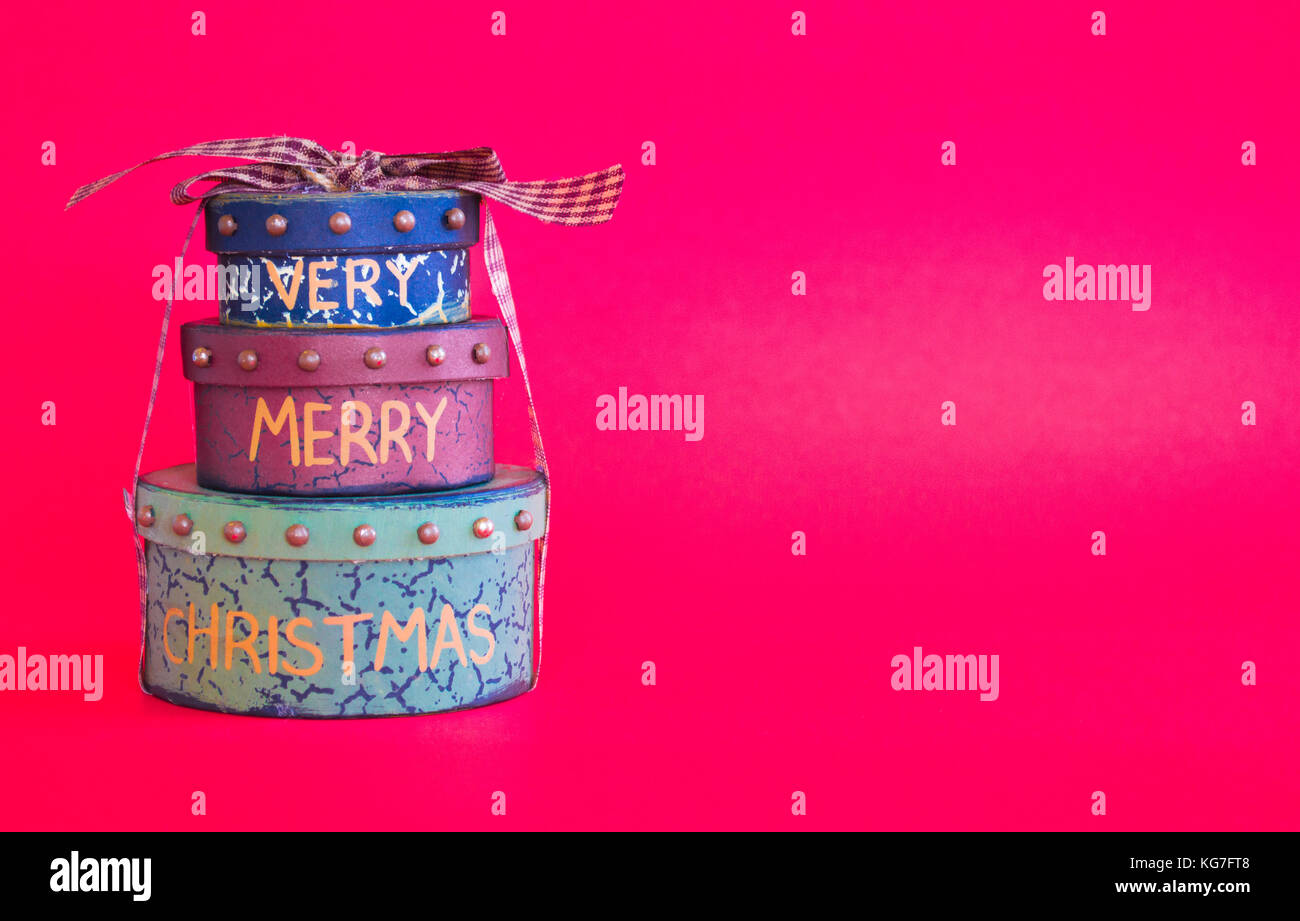 stack of 3 Christmas gift boxes tied with ribbon isolated on red ...