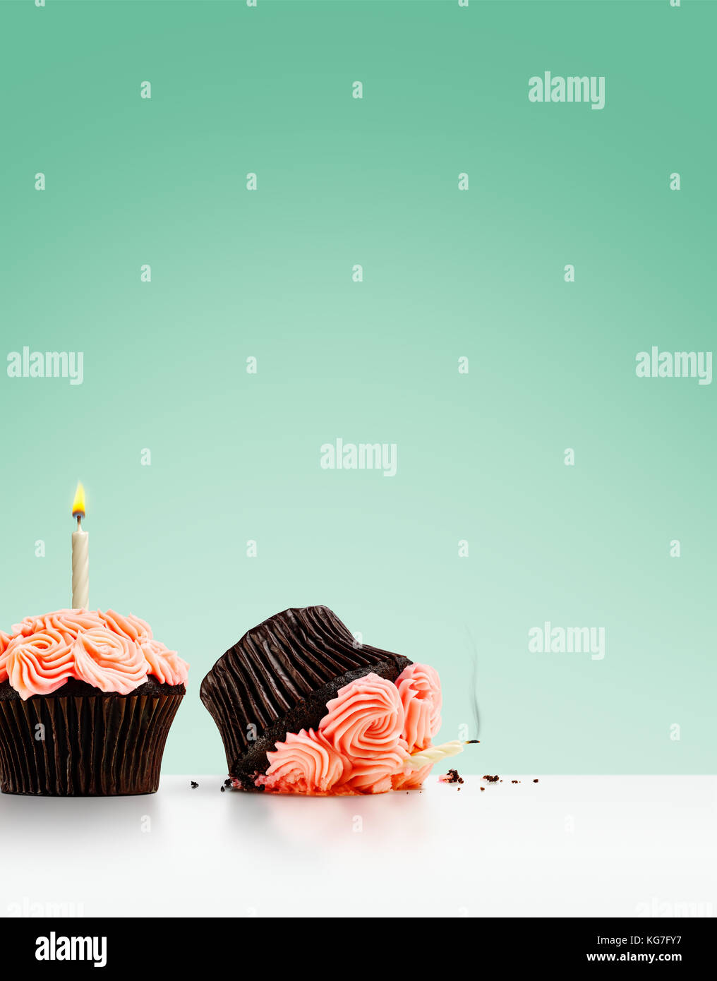 Smashed cupcake in row of cupcakes with candles on green background ...
