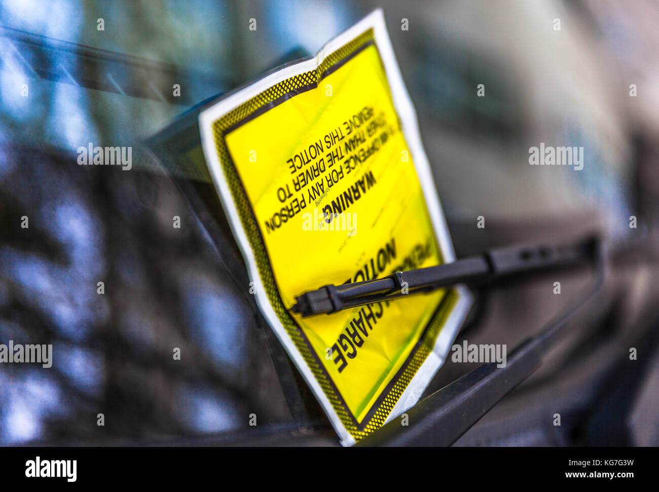 A penalty charge notice (PCN) weighed down with wiper, on a car ...