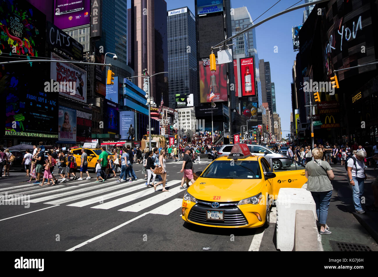 Unidentified people on the Times Square, New York. Times Square is the ...