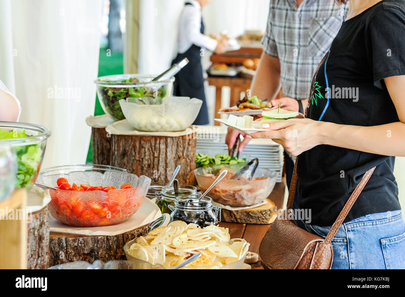 Outdoor Cuisine Culinary salad bar Catering. Group of people in all you ...