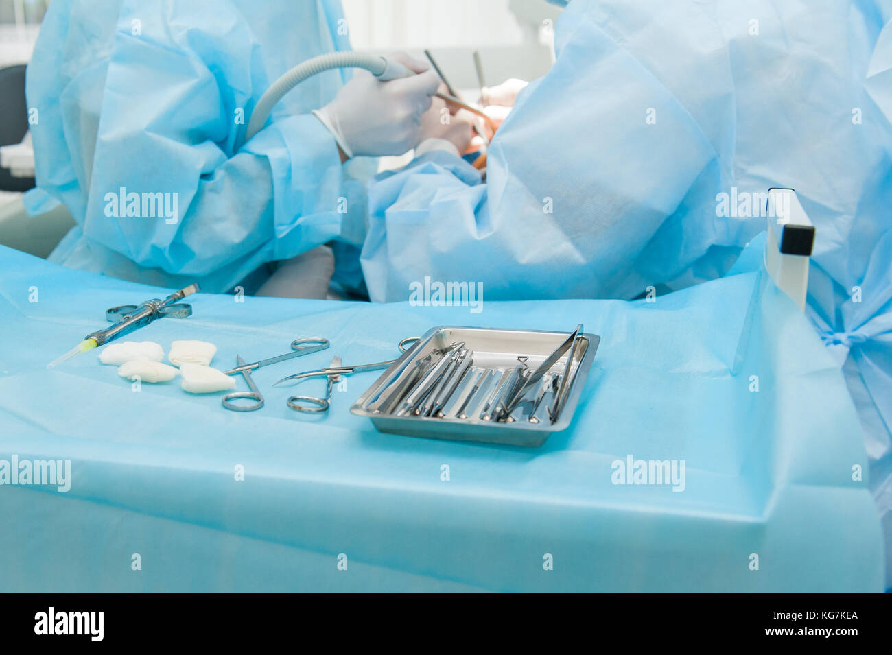 Close up dental surgery process - Implantation. Dentist surgeon with ...