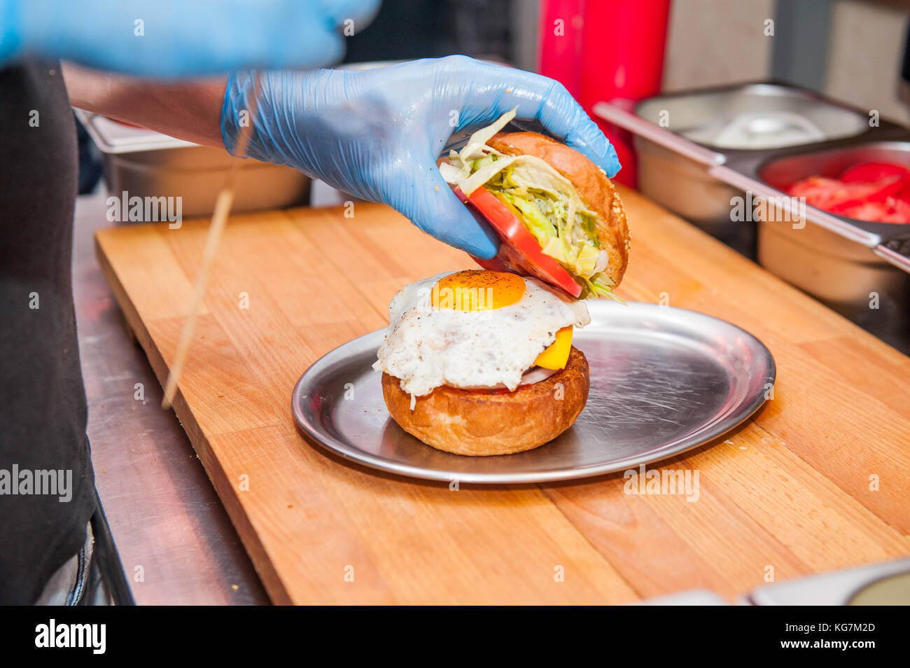 Chief cook preparing fresh burger in the kitchen.Burger restaurant menu ...