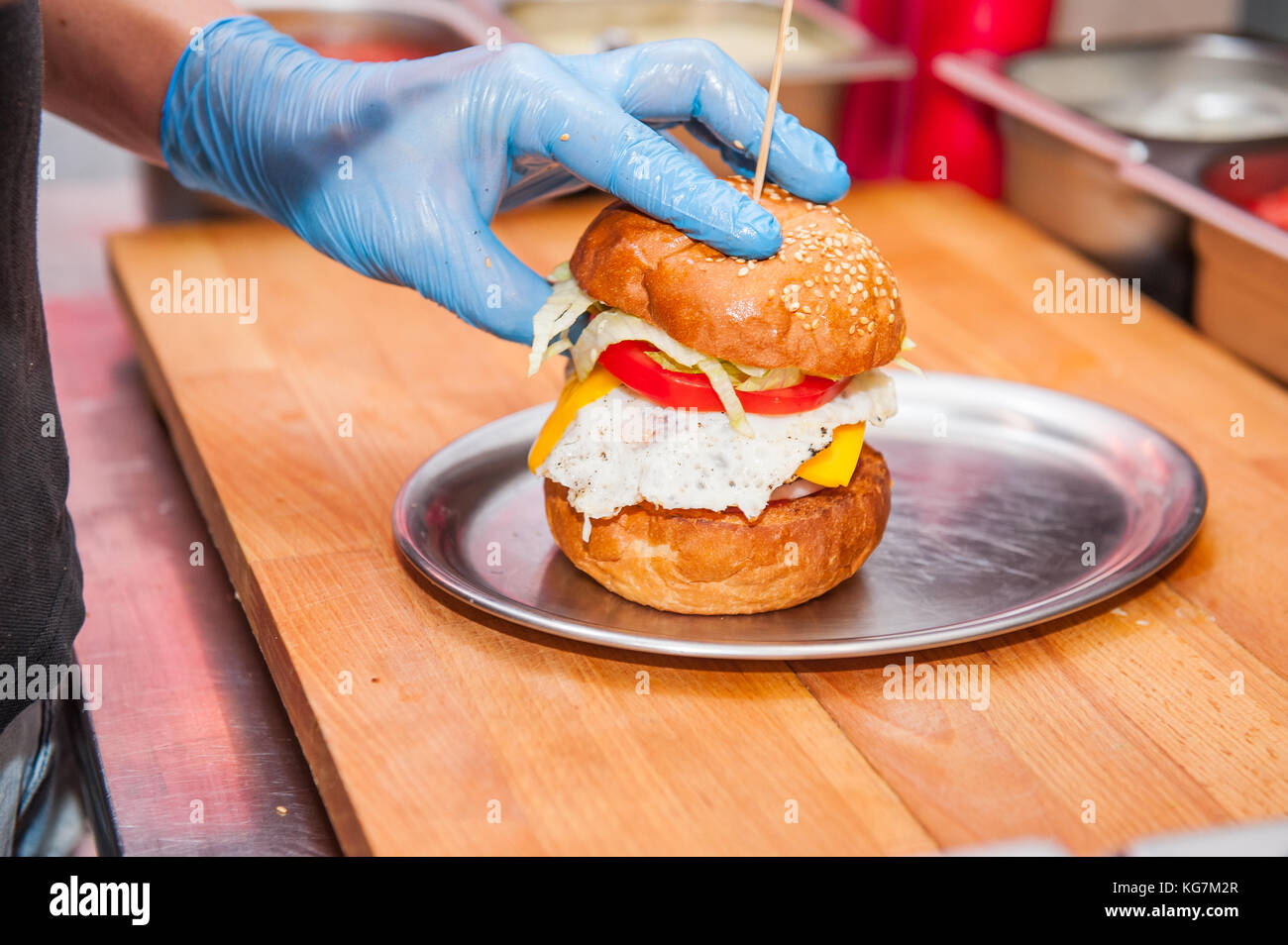 Chief cook preparing fresh burger in the kitchen.Burger restaurant menu ...