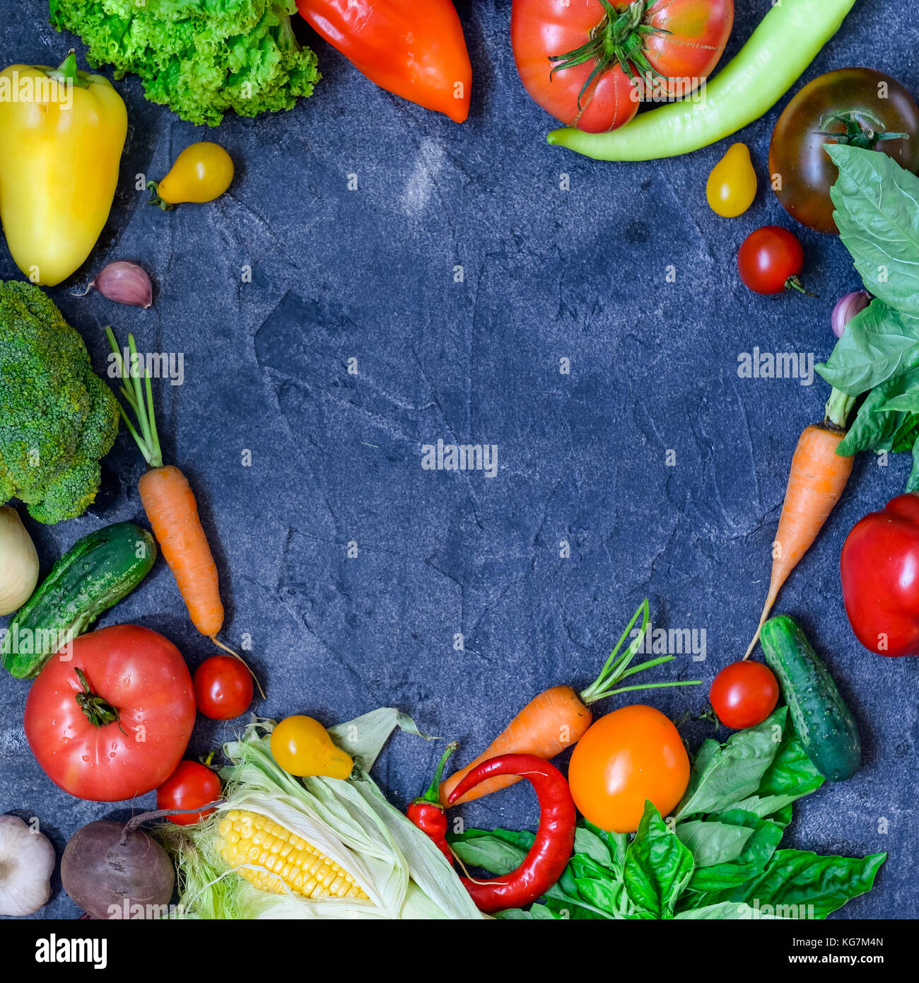 Frame of organic food. Fresh raw vegetables and greens on the dark ...