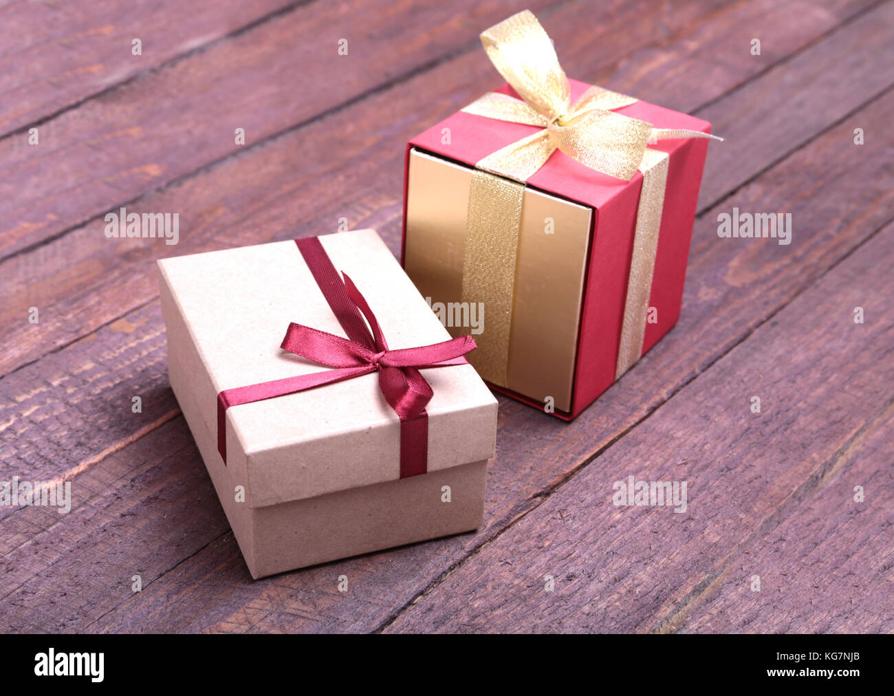red and gold gift box on wood background Stock Photo - Alamy