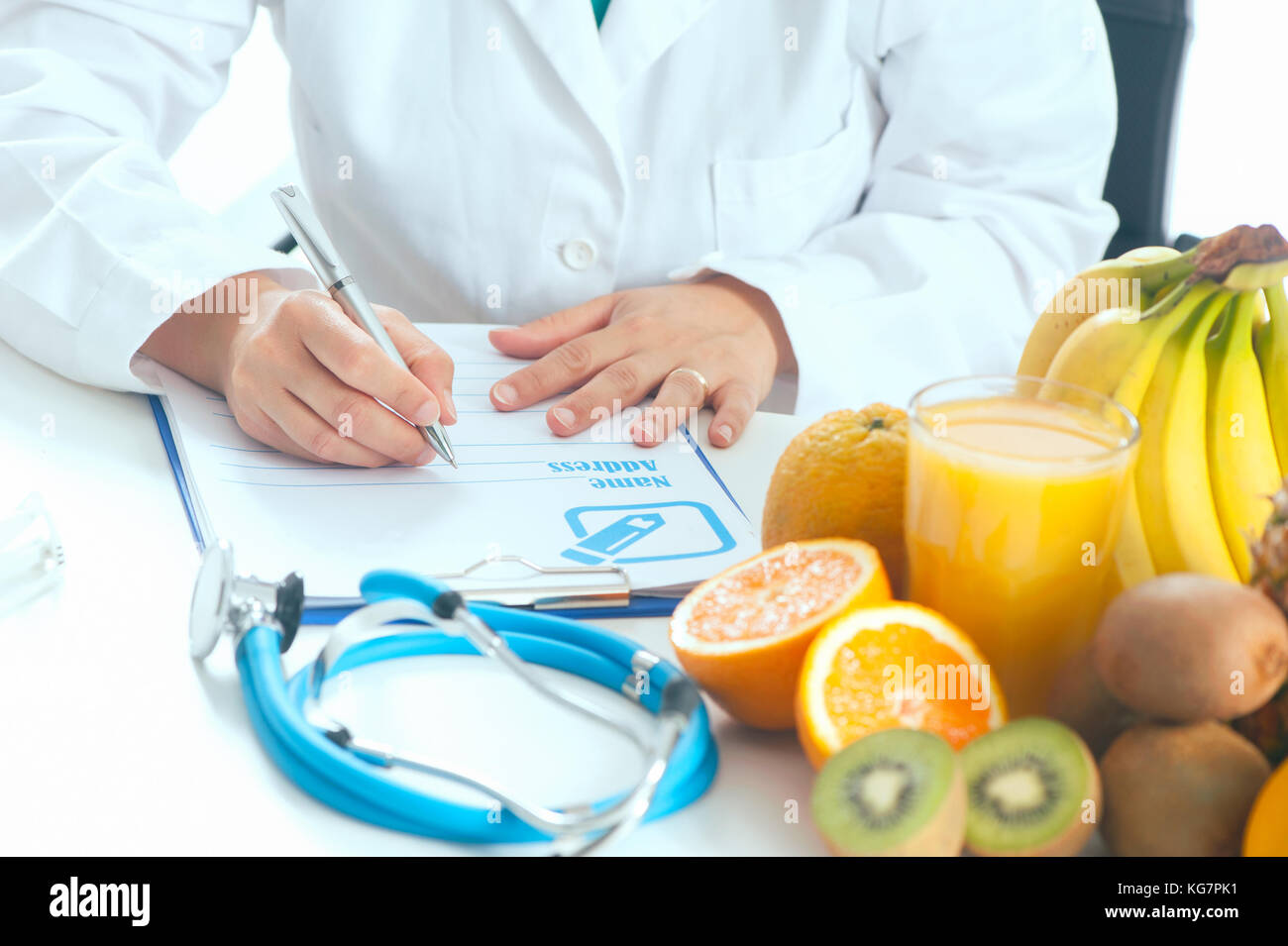 nutrionist writing a diet plan on table Stock Photo - Alamy