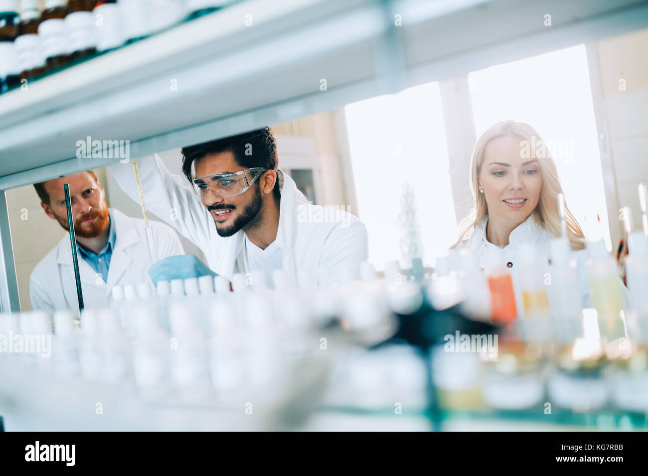 Group of chemistry students working in laboratory Stock Photo - Alamy