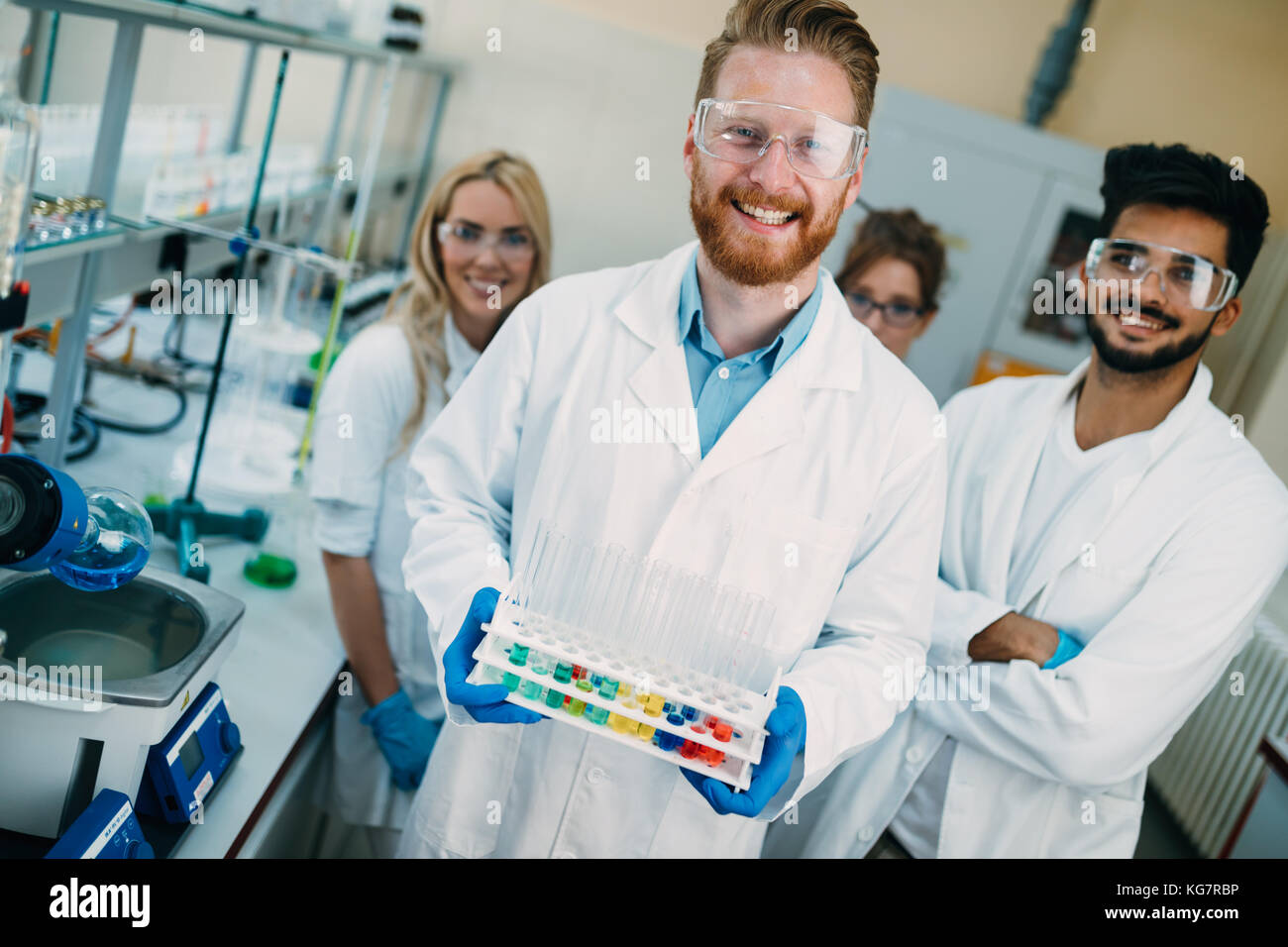 Group of young successful scientists posing for camera Stock Photo - Alamy