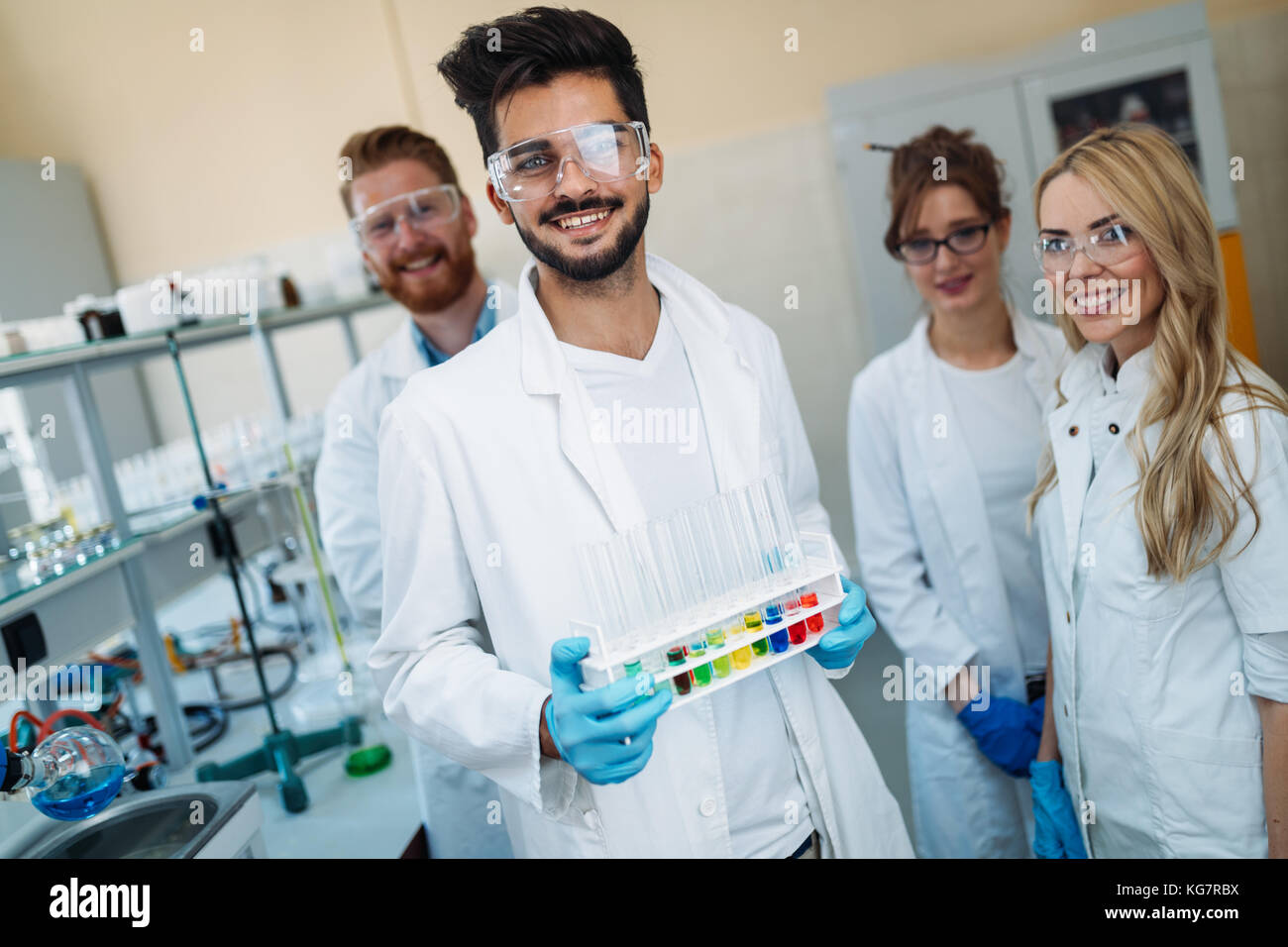 Group of young successful scientists posing for camera Stock Photo - Alamy