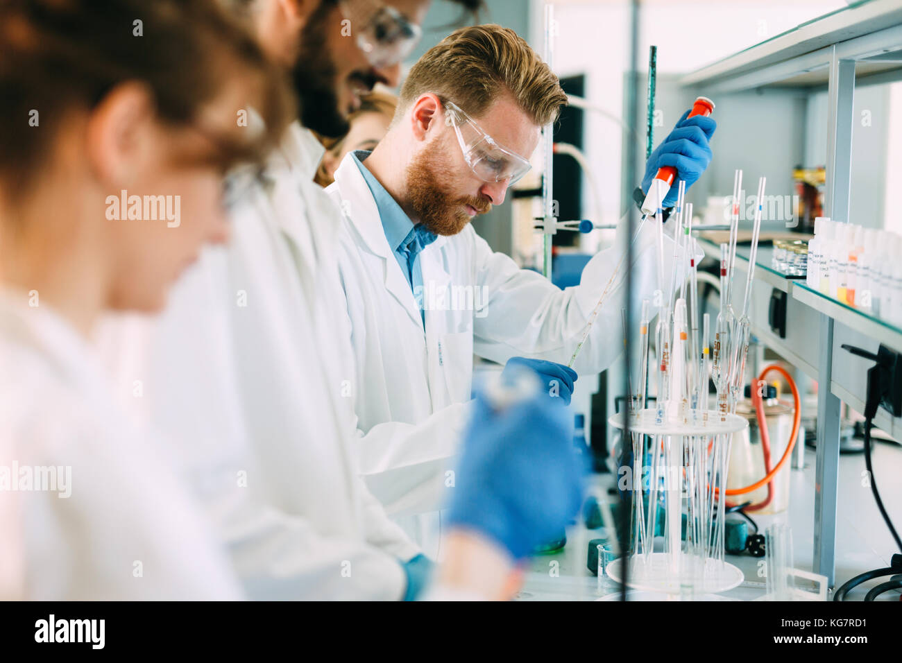 Group of chemistry students working in laboratory Stock Photo - Alamy