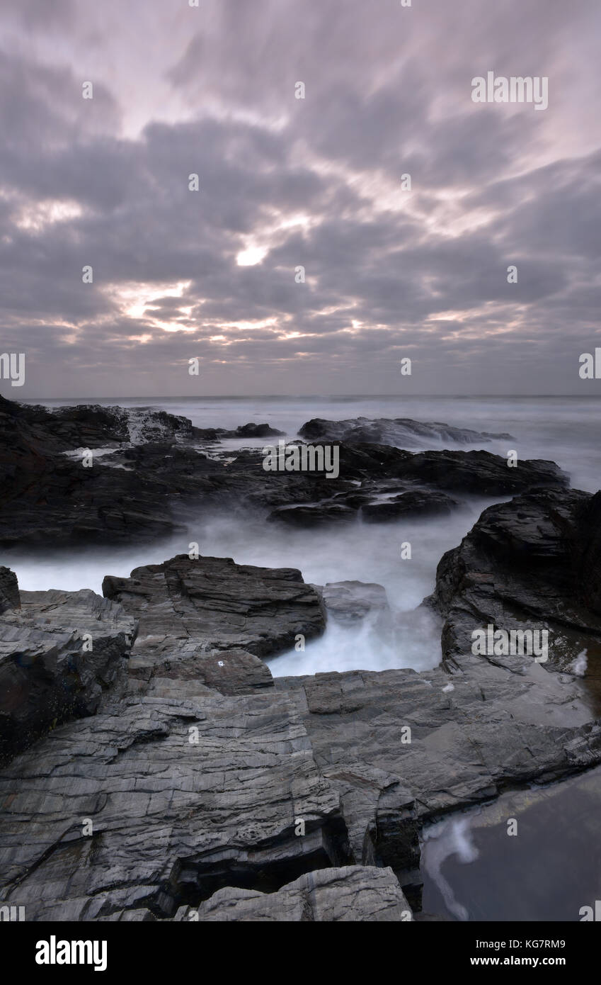 an atmospheric seascape on the Cornish coast with rugged rocky beaches ...