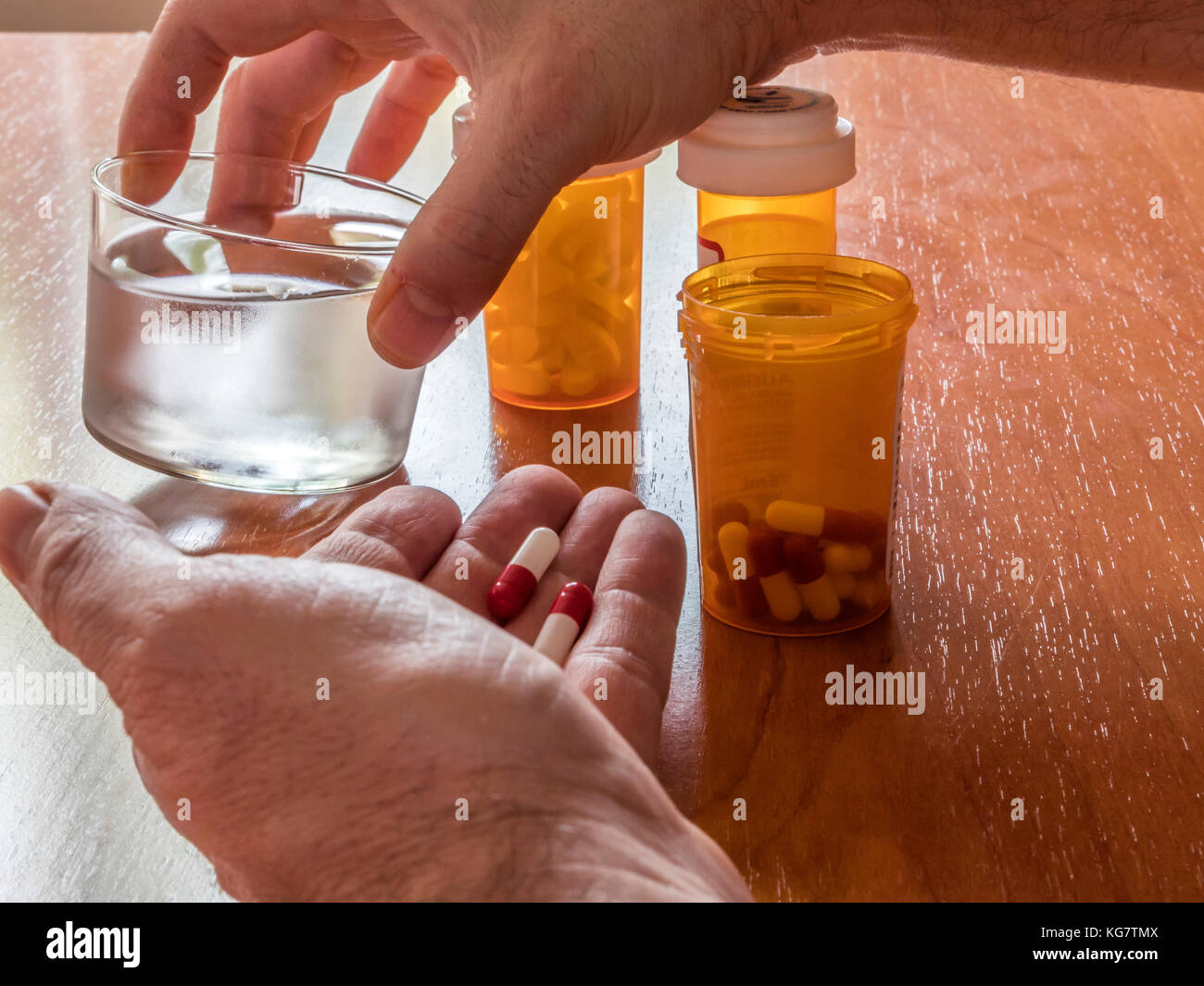 Person Taken Its Daily Medication With A Water Glass Stock Photo - Alamy
