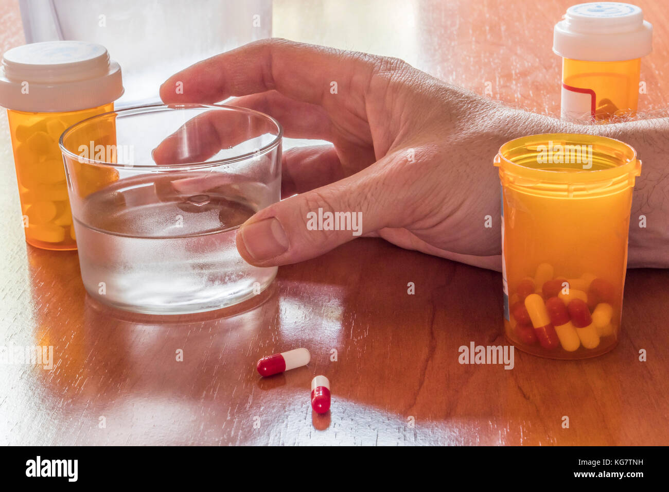 Person Taken Its Daily Medication With A Water Glass Stock Photo - Alamy