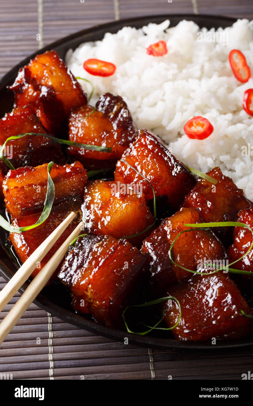 Vietnamese festive meal: red pork belly with rice close-up on a plate ...