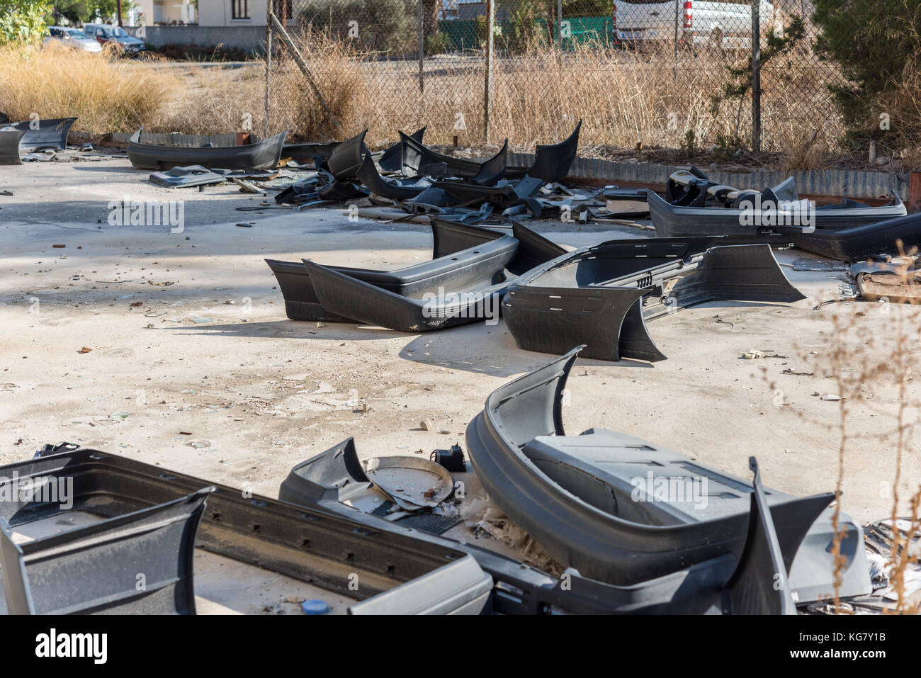 Old car bumbers and other car parts at abandoned car service building ...