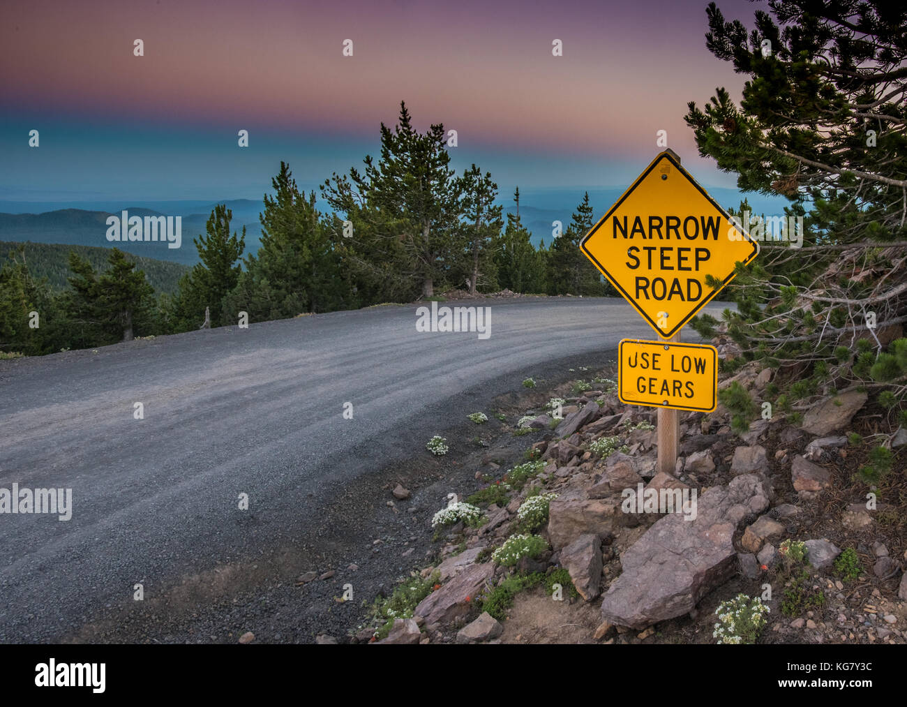 Narrow Steep Road Sign at Sunset along gravel road Stock Photo - Alamy