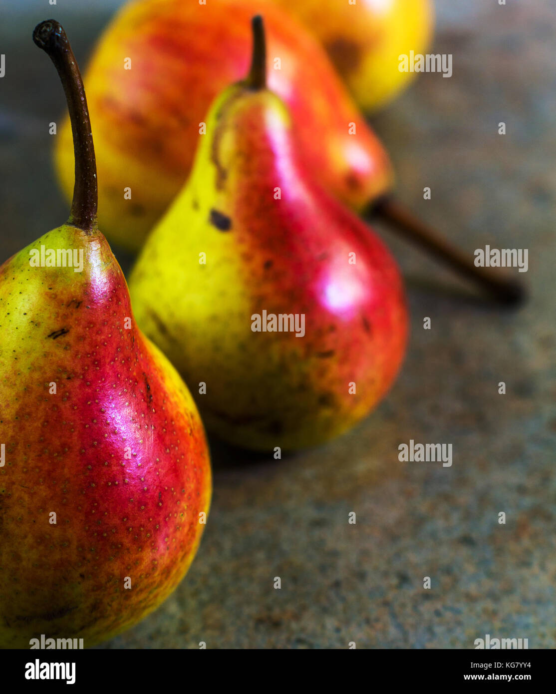 ripe pear with red side on rustic stone table Stock Photo - Alamy