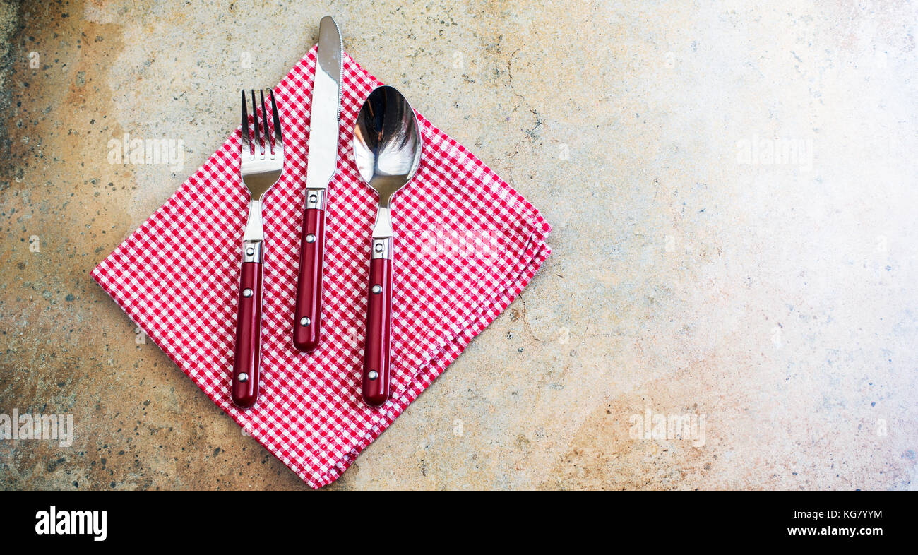 Rustic table setting with vintage silverware and plates on stone table ...