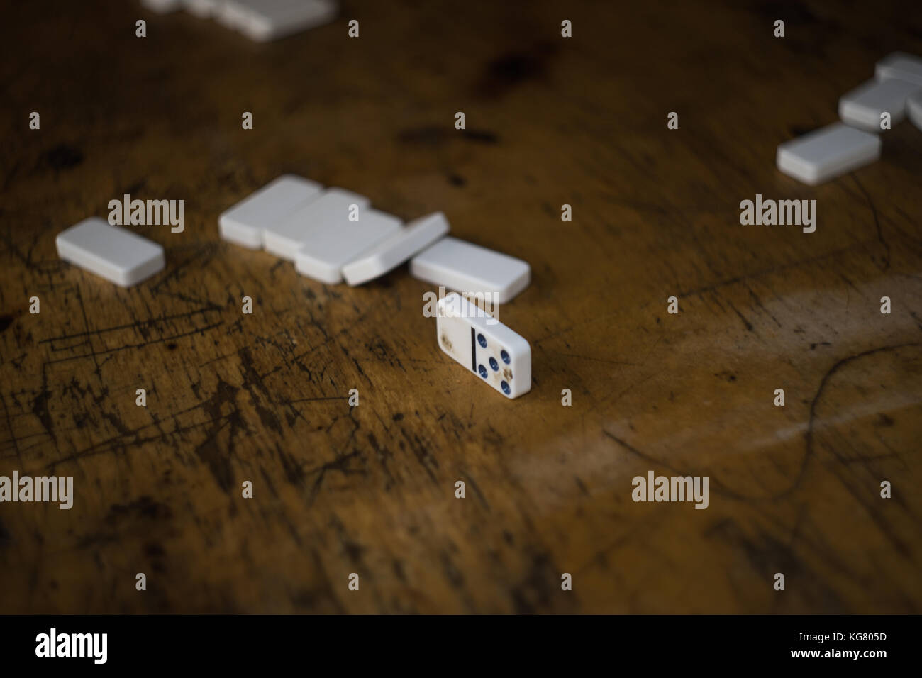 Falling domino on old outdoor table waiting for game Stock Photo - Alamy