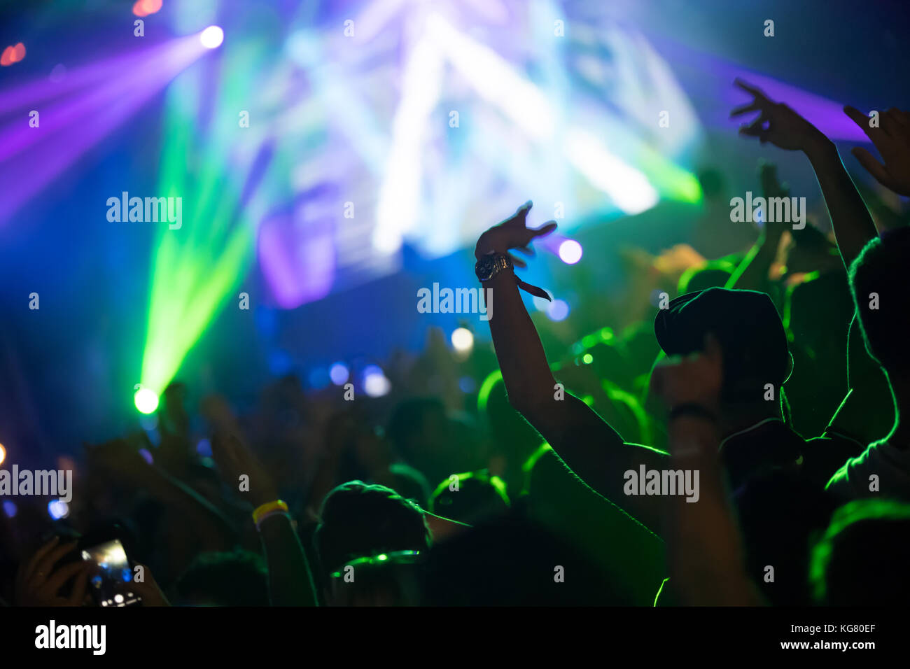 Cheering crowd at concert enjoying music performance Stock Photo - Alamy