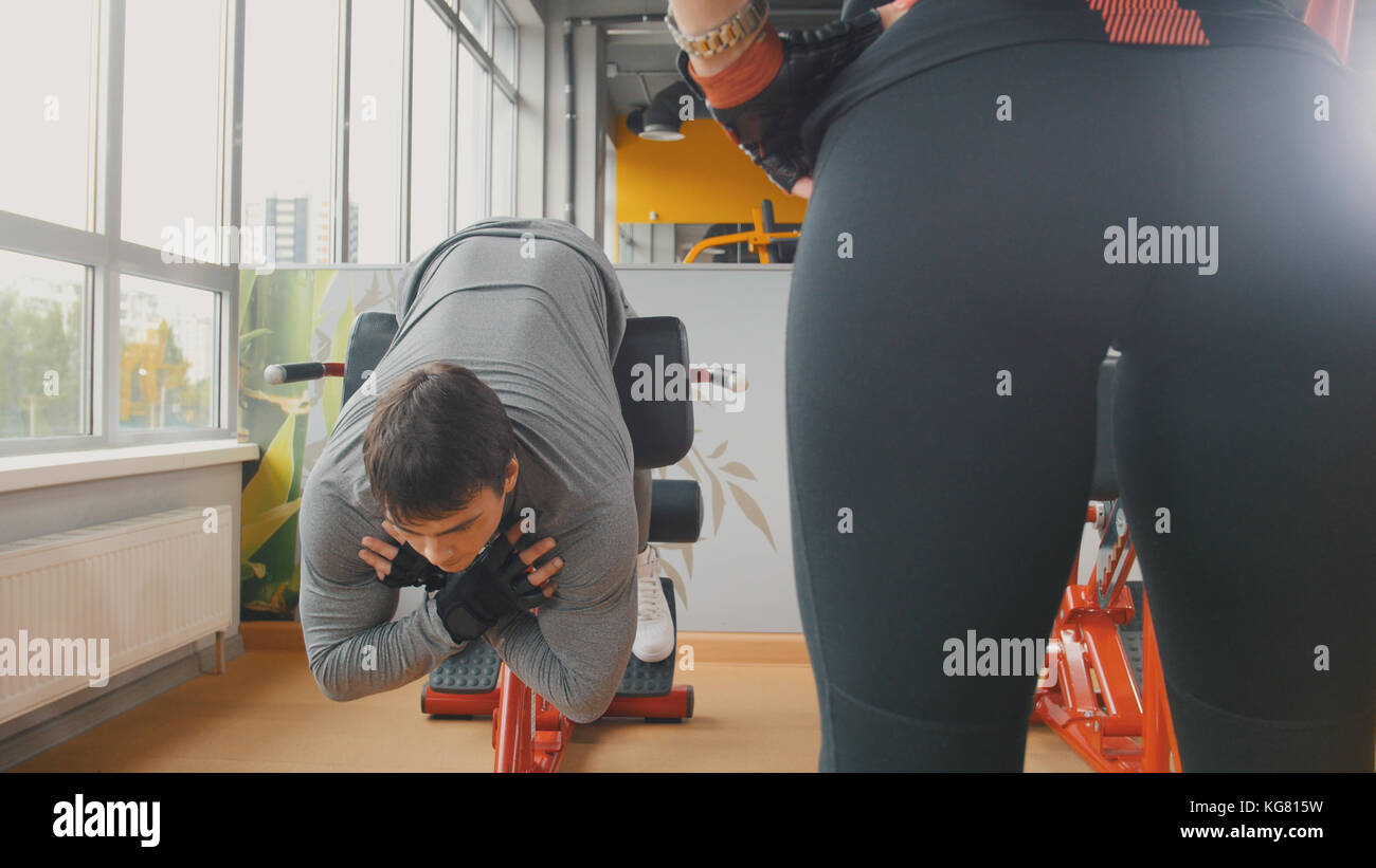 In the gym -young man athlete doing exercises for abdominal in gym ...