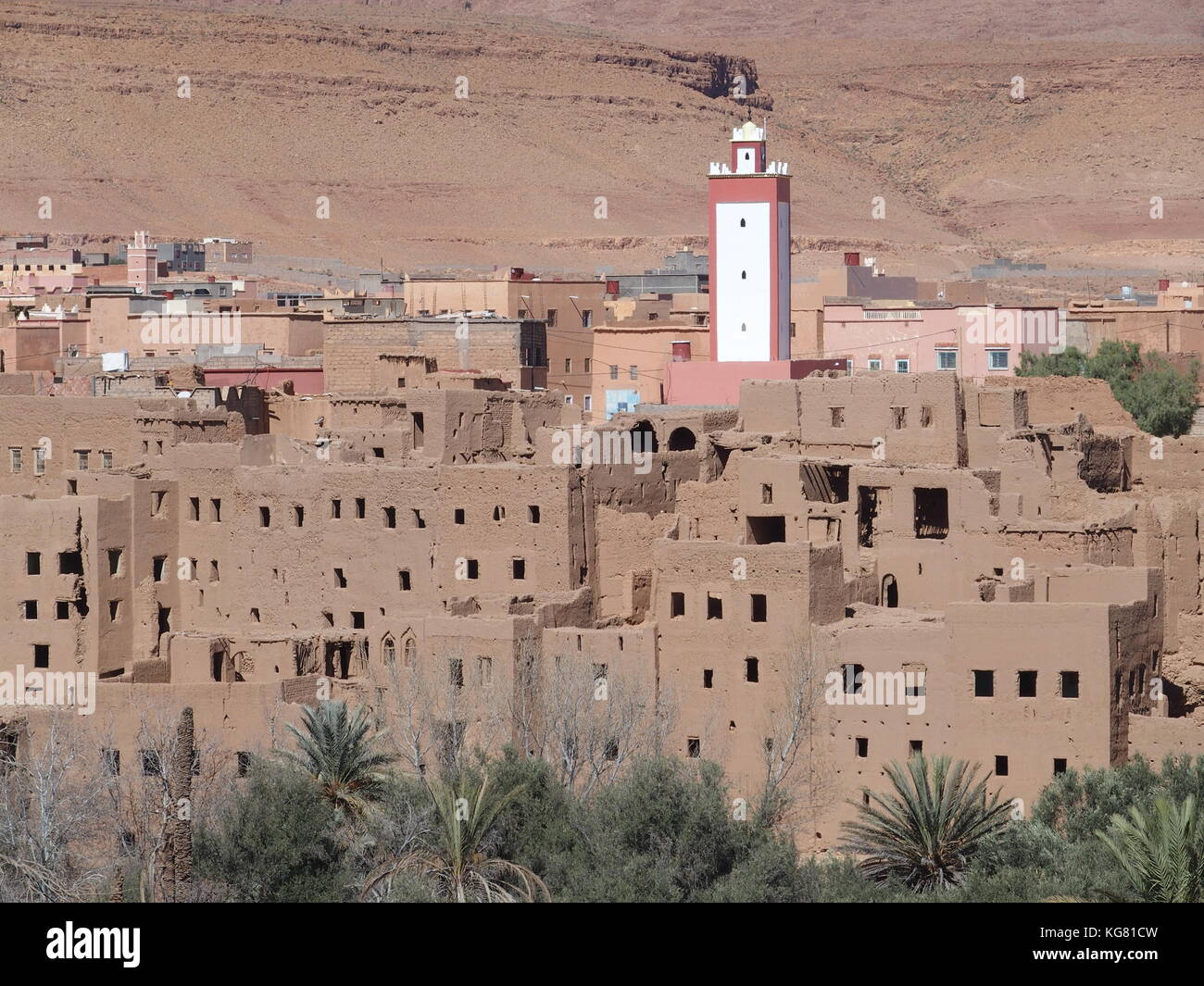 Old town of Tinghir with minaret, green palm oasis and rocky Atlas ...