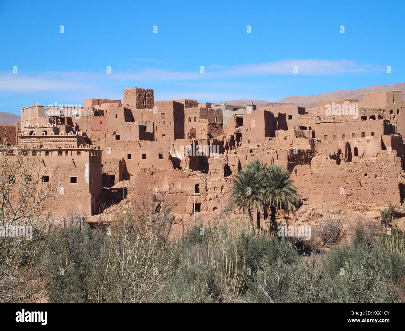 Old town of Tinghir, green palm oasis and rocky Atlas Mountains range ...