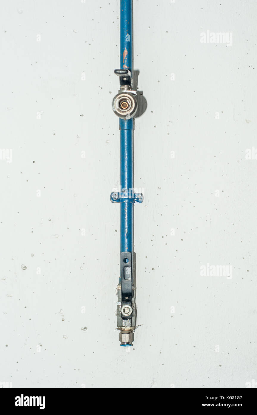 water metal pipe with tap on a white wall Stock Photo - Alamy
