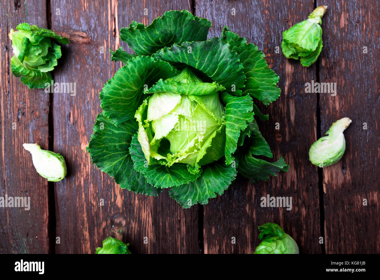 Fresh green cabbage big and small on wooden background. Top view. Copy ...