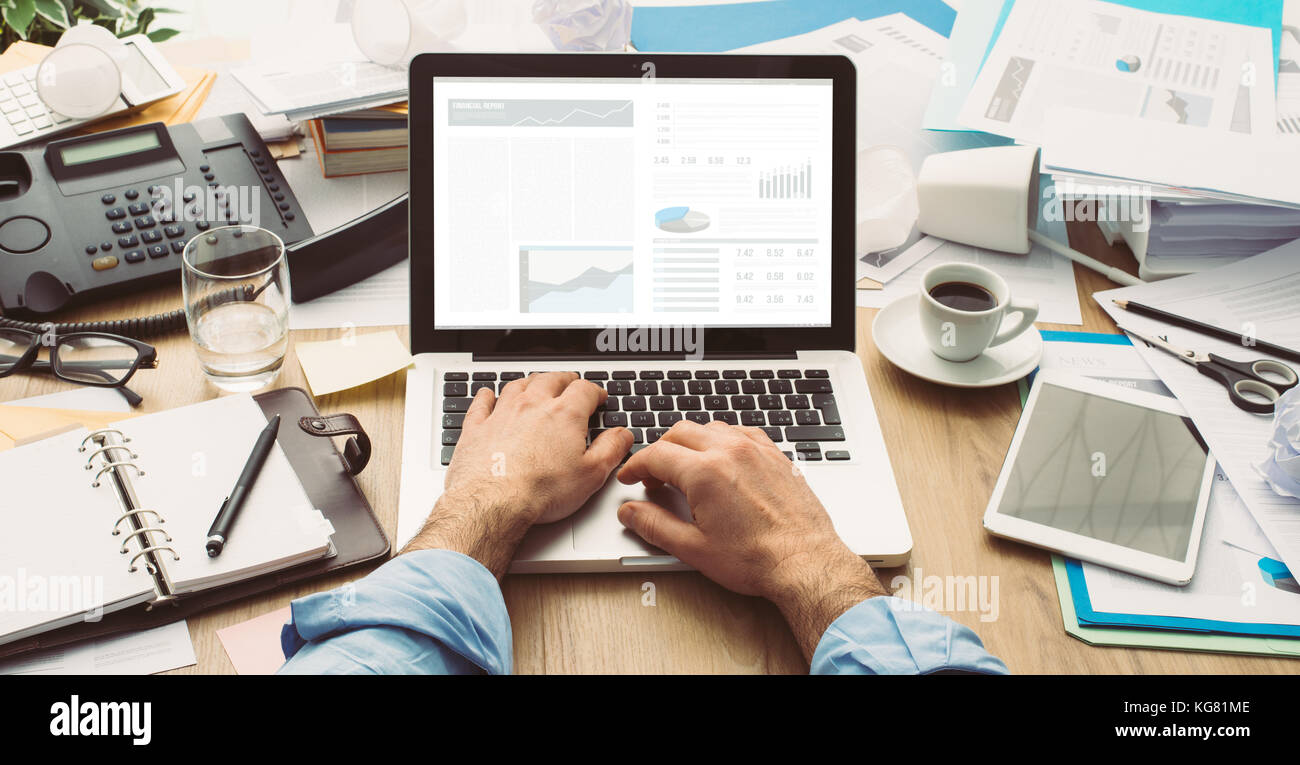Corporate businessman working in the office and typing with a laptop ...