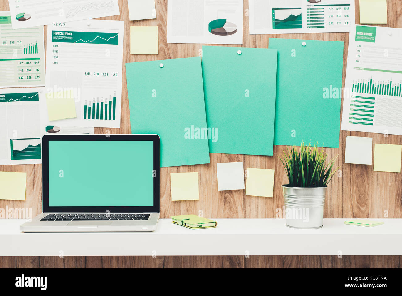 Desktop with laptop and paperwork hanging on the office wooden wall and ...