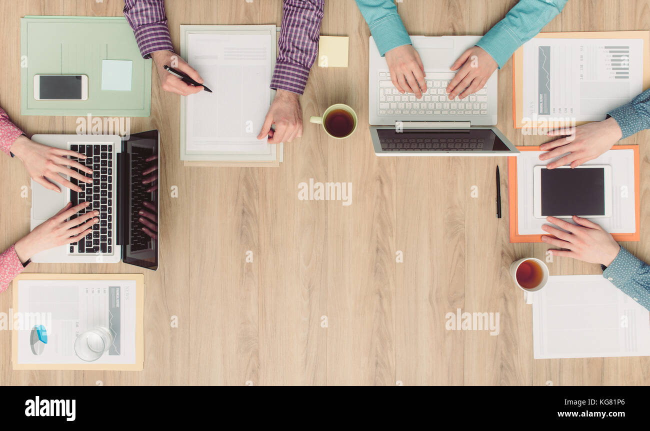 Coworkers and business team working together at office desk ...