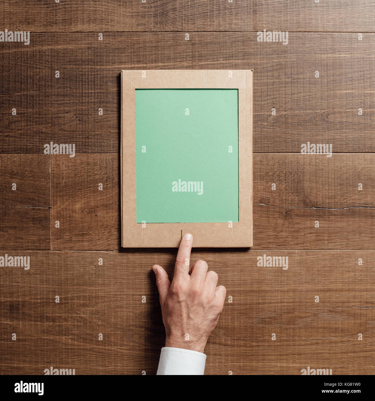 Man using an eco-friendly creative tablet made from recycled cardboard ...