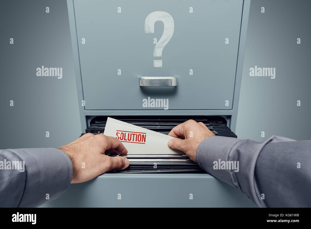 Office clerk searching for files in the filing cabinet, he finds a ...