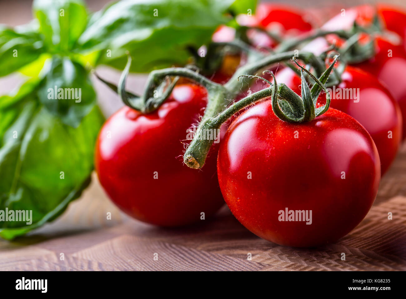 Tomatoes. Cherry tomatoes. Cocktail tomatoes on wooden board Stock ...
