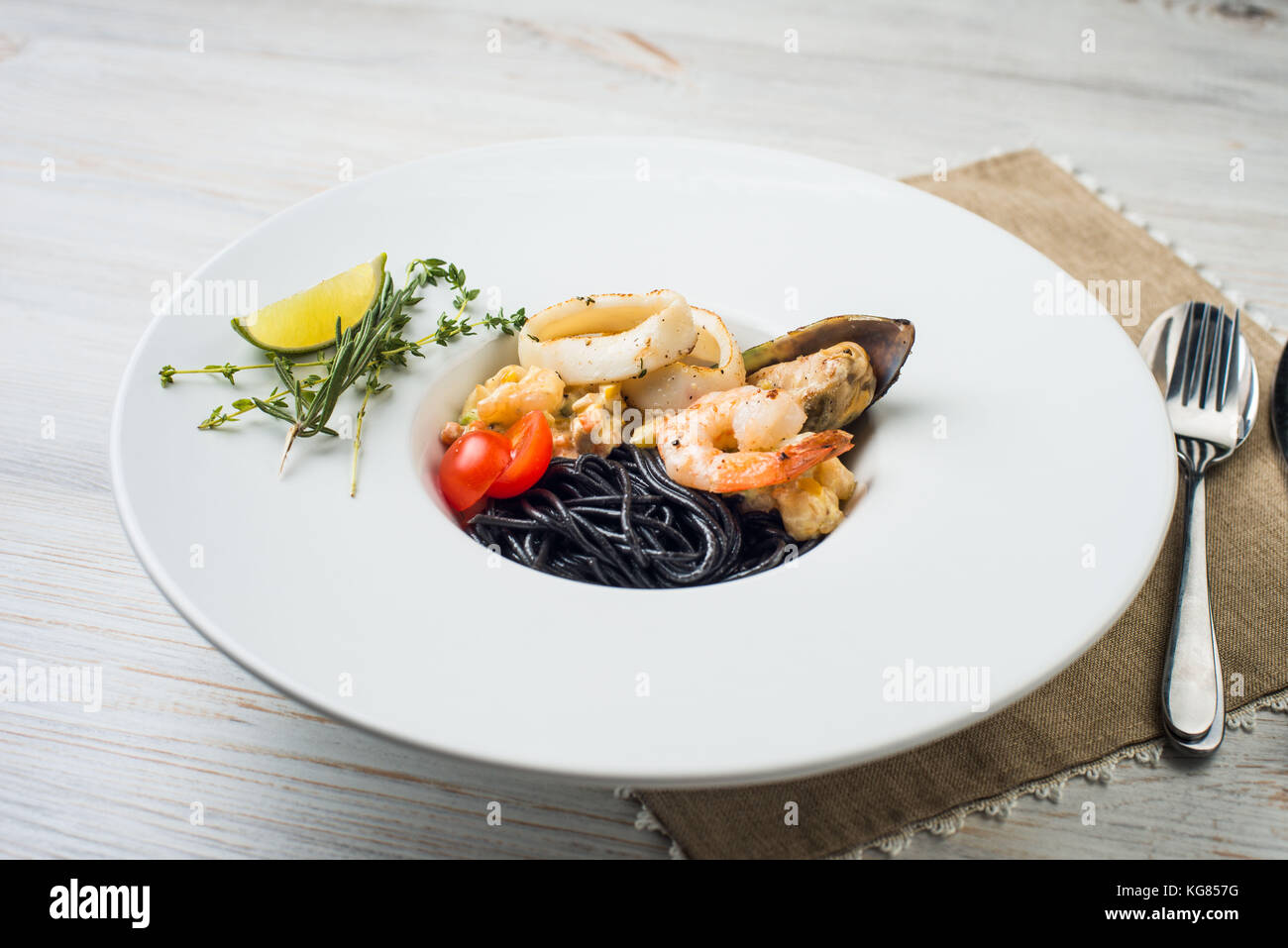 Italian black spaghetti with cuttlefish ink, mussels, tomatoes and ...