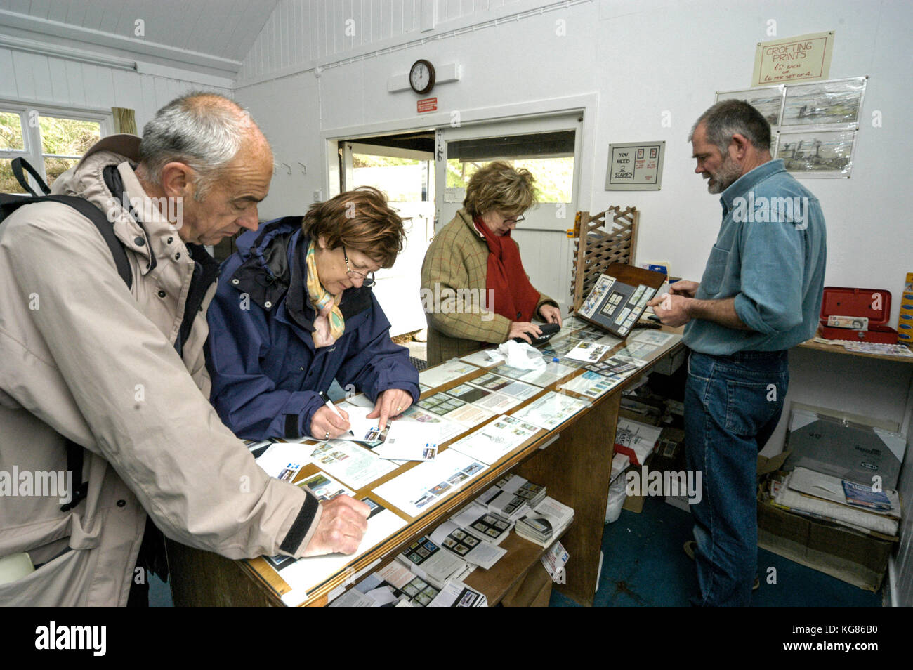 Visitors purchase some postage stamps from the postmaster, David ...