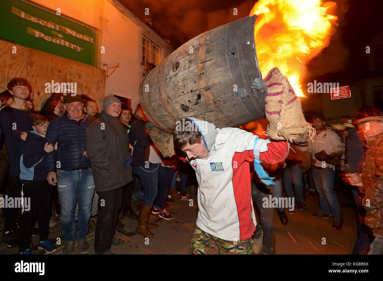 Participants run with a burning barrel soaked in tar at the annual ...