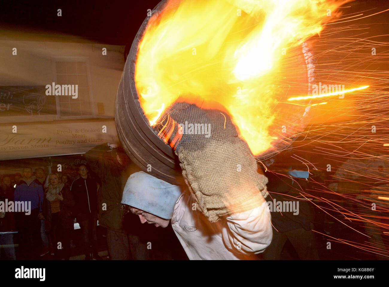 Participants run with a burning barrel soaked in tar at the annual ...