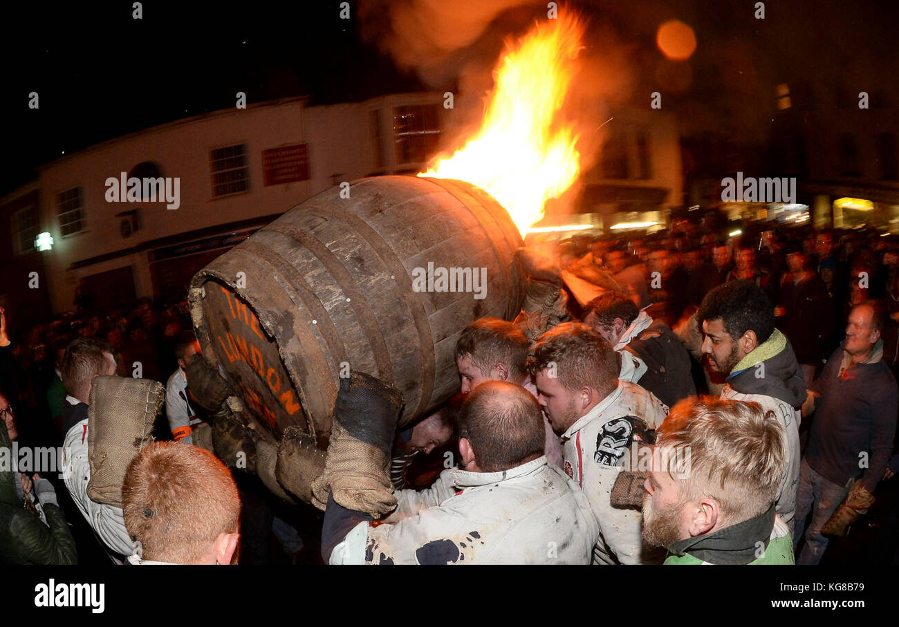 Participants run with a burning barrel soaked in tar at the annual ...