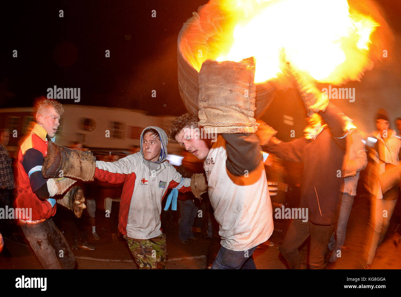 Participants run with a burning barrel soaked in tar at the annual ...