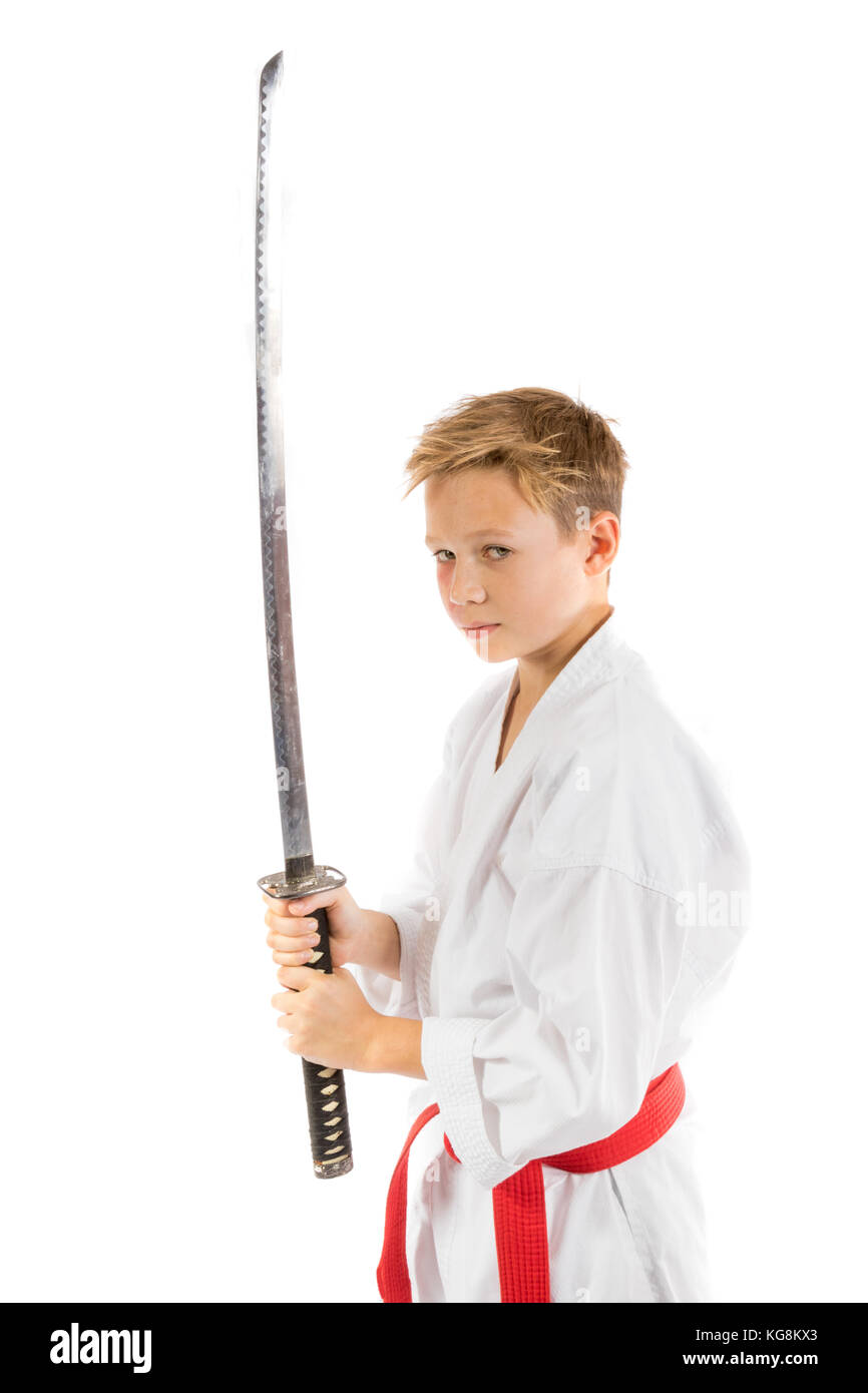 Pre-teen boy with a samurai sword isolated on a white background Stock ...