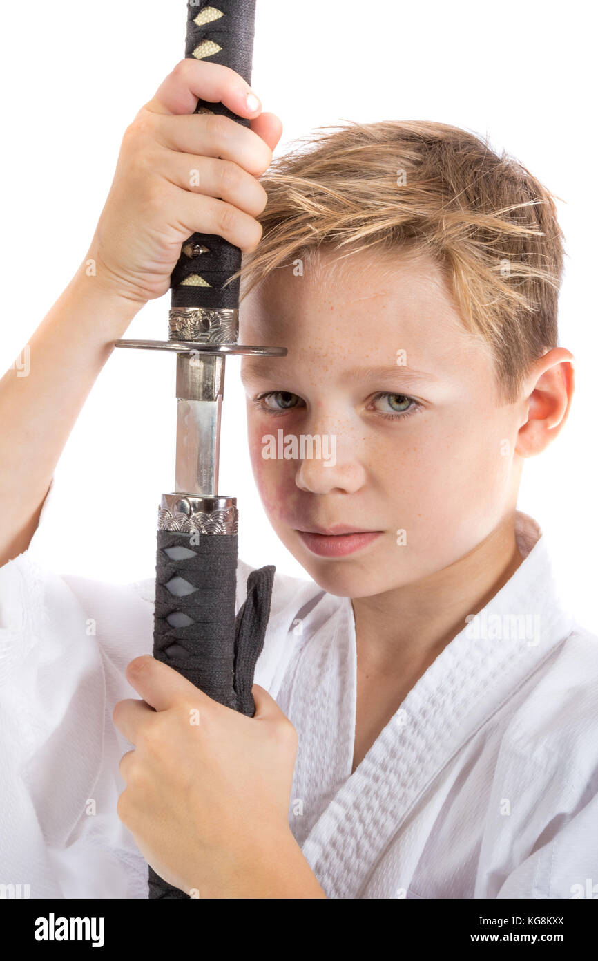 Pre-teen boy with a samurai sword isolated on a white background Stock ...