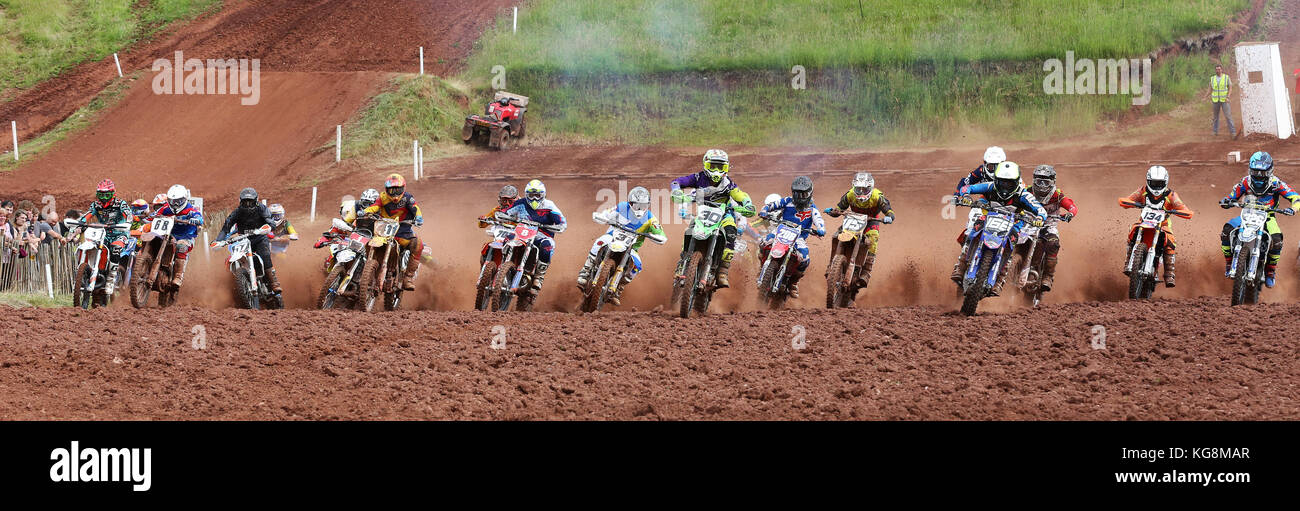 Motocross bikes approach the first corner in race Stock Photo - Alamy