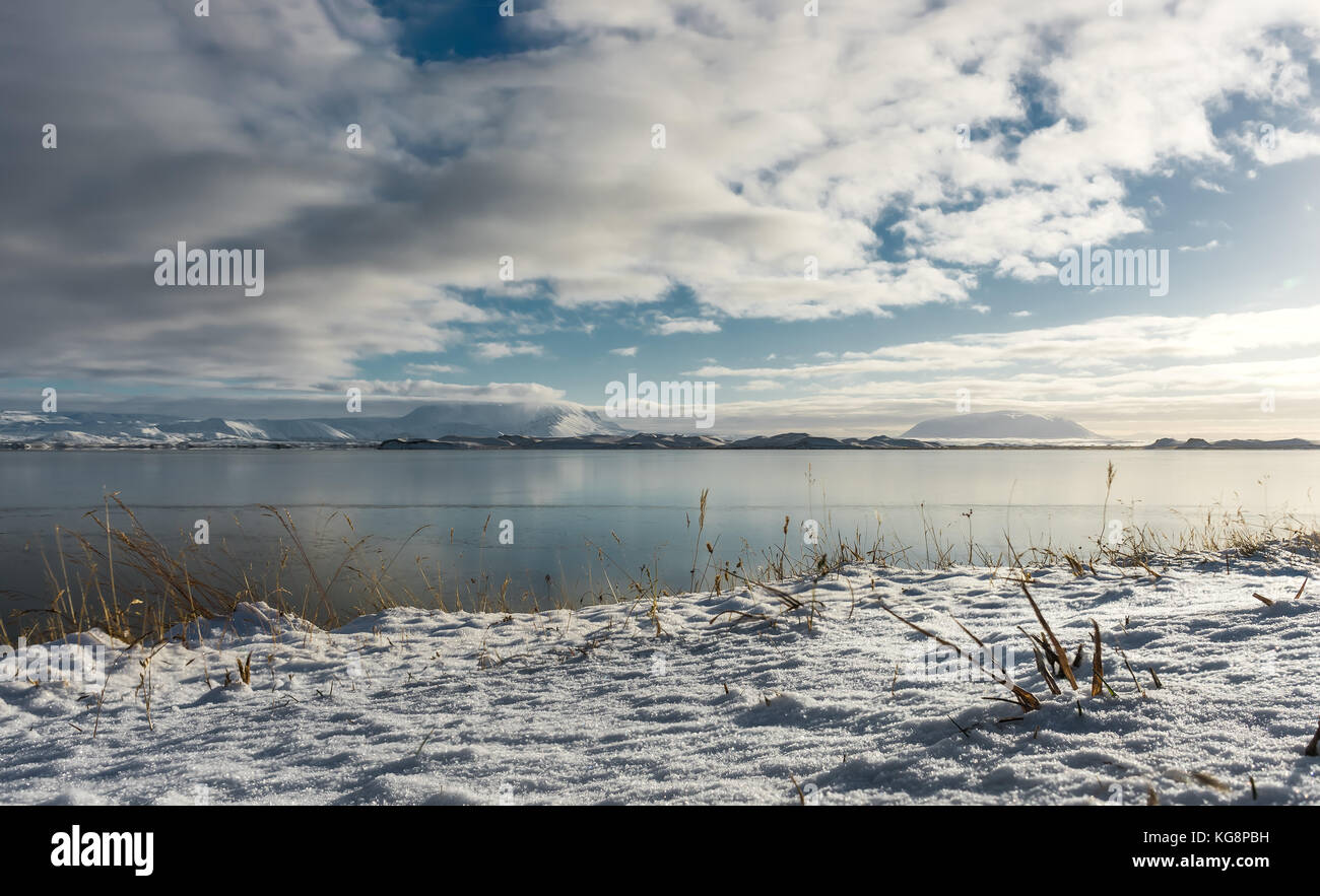 Frozen Lake with Volcano blue Sky and Snow reflection white in I Stock ...